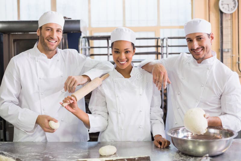Team of Bakers Smiling at Camera Stock Photo - Image of kitchen ...