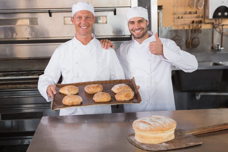 Team of Bakers Smiling at Camera with Trays of Croissants Stock Photo ...