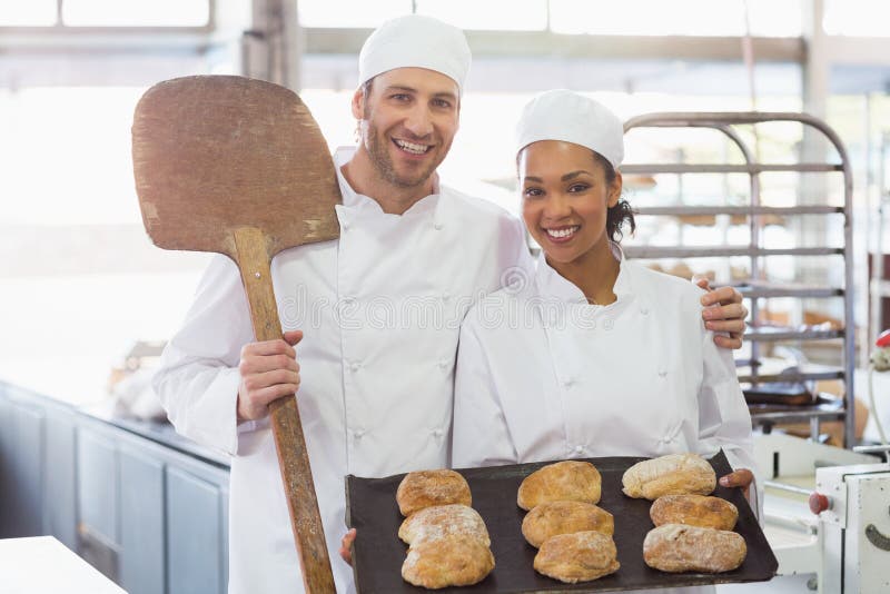 Team of Bakers Smiling at Camera with Trays of Loaves Stock Image ...