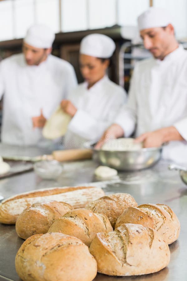 Team of Bakers Working at Counter Stock Photo - Image of female, bread ...