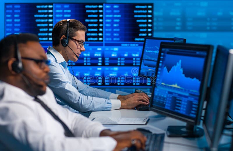 Team of Brokers is Working in Office Using Workstation and Analysis ...