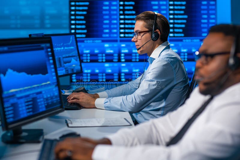 Team of Brokers is Working in Office Using Workstation and Analysis ...