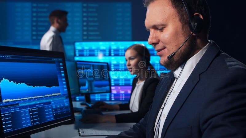 Team of Brokers is Working in Office Using Workstation and Analysis ...