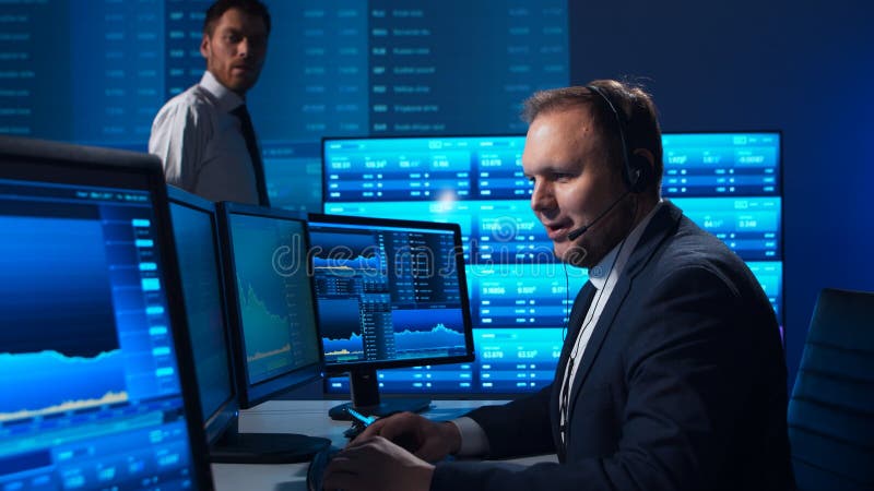 Team of Brokers is Working in Office Using Workstation and Analysis ...