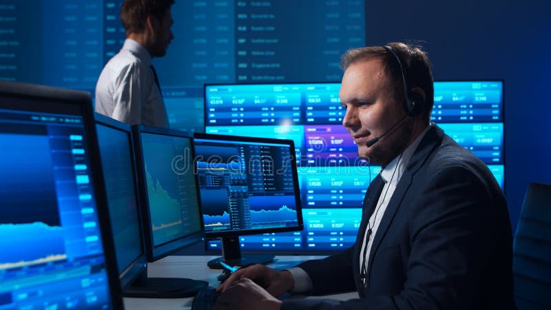 Team of Brokers is Working in Office Using Workstation and Analysis ...