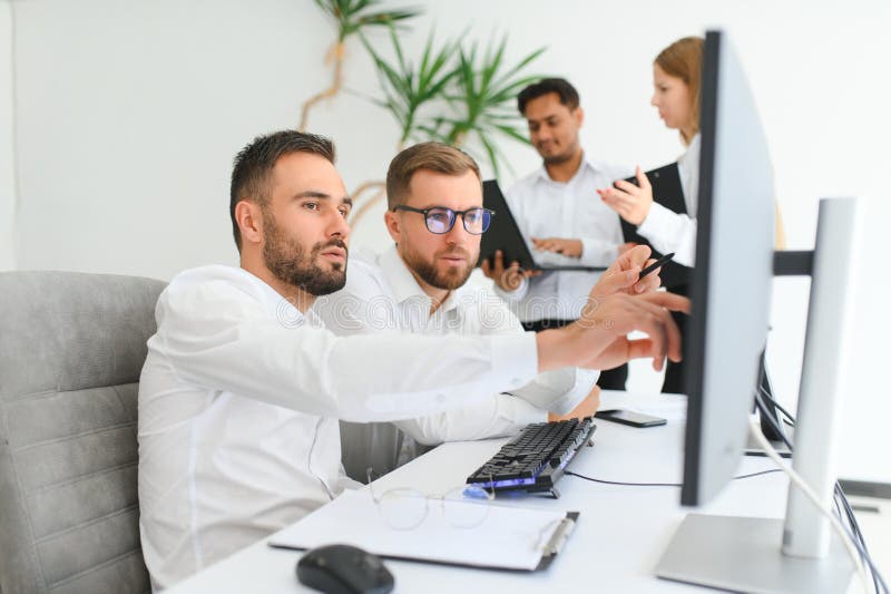 Team of Brokers is Working in Office Using Workstation and Analysis ...