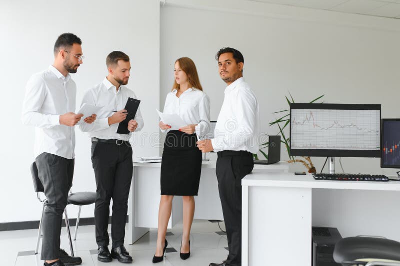 Team of Brokers is Working in Office Using Workstation and Analysis ...