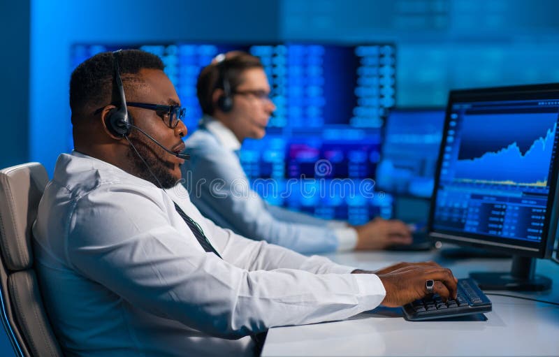 Team of Brokers is Working in Office Using Workstation and Analysis ...