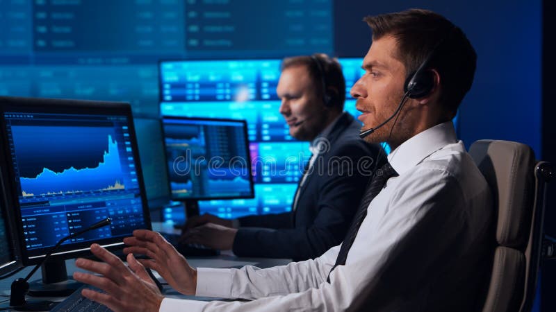 Team of Brokers is Working in Office Using Workstation and Analysis ...