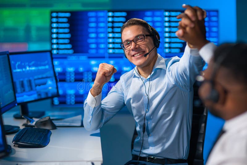 Team of Brokers is Working in Office Using Workstation and Analysis ...