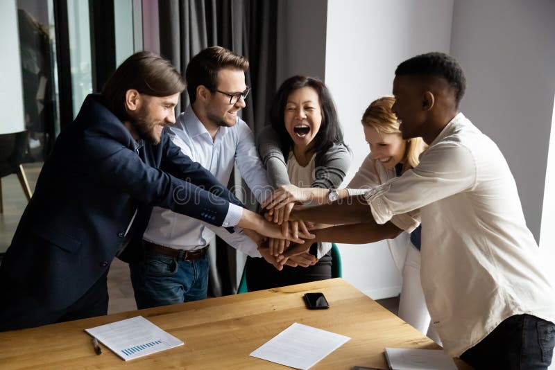 Cheerful Diverse Workmates Stack Palms Arms Together Celebrating Common ...