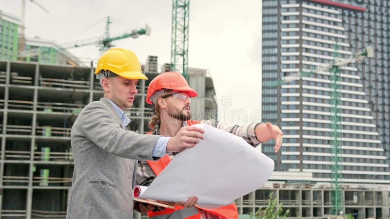 Team of Building Experts with Drawings Inspecting New Development Site Stock Video - Video of ...