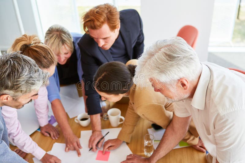 Team of Business Colleagues Discussing Over Documents during Meeting in ...