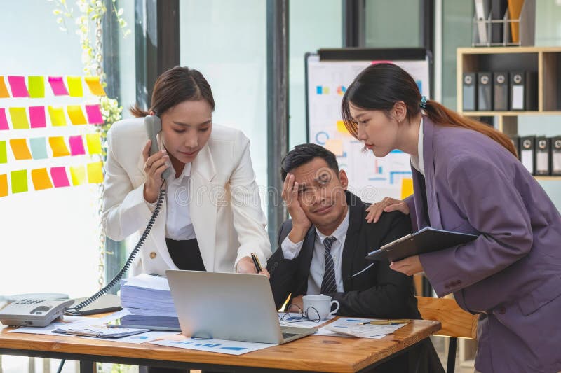 A Team of Business People are Busy Working on the Phone. Laptop ...