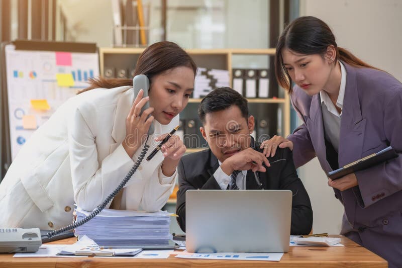 A Team of Business People are Busy Working on the Phone. Laptop ...