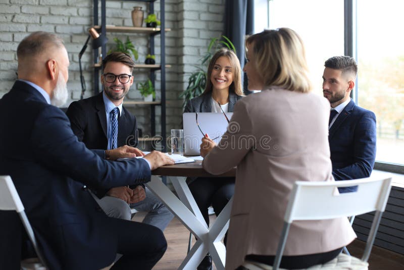 Team of Business People Having Discussion at Table in Creative Office ...