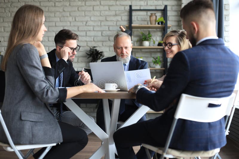 Team of Business People Having Discussion at Table in Creative Office ...