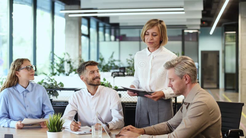 Team of Business People Having Discussion at Table in Creative Office ...
