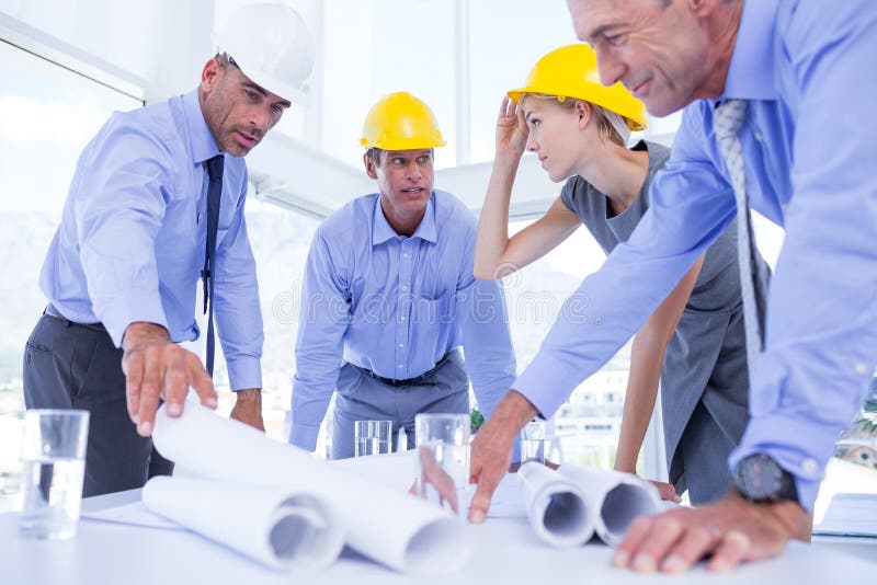 Team of Business People Looking at Construction Plan Stock Photo ...