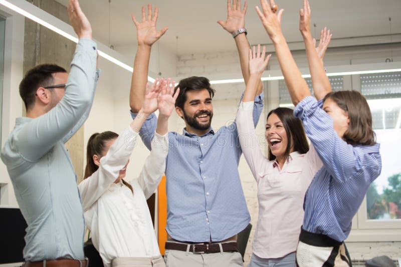 Team of Business People with Their Hands Up Celebrating Successful ...