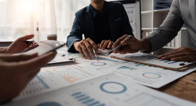 Team Business Using a Calculator and Tablet To Calculate the Numbers of ...