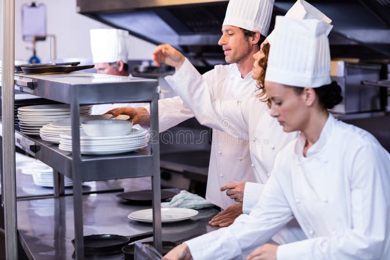 Busy Chefs at Work in the Kitchen Stock Photo - Image of sauce, dish ...