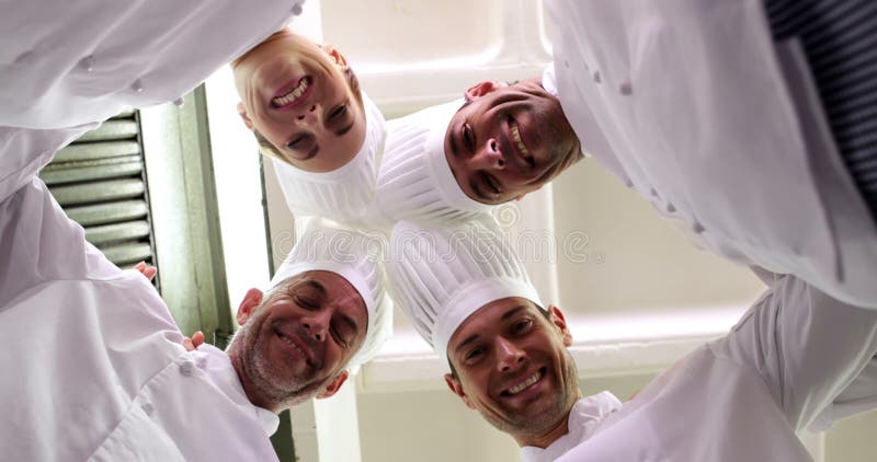 Team of Chefs Standing in Circle Looking Down at Camera Stock Footage ...