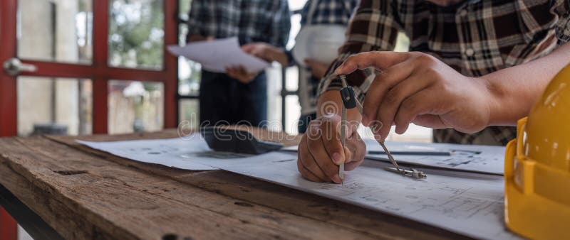 Team of Civil Engineers Meeting at Construction Site in Modern City To Plan the Work and Layout ...