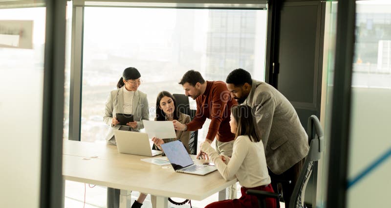 Team Collaborates in Modern Office Setting on Innovative Project with ...