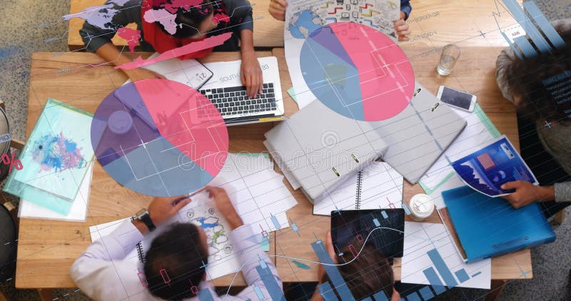 Team Collaborating on Project with Laptops and Documents at Modern ...