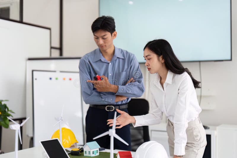 Team Collaboration on Sustainable Engineering. Engineers Brainstorming Solutions for Eco ...