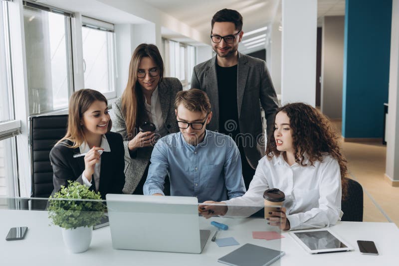Team of Colleagues Brainstorming Together while Working on the Computer ...