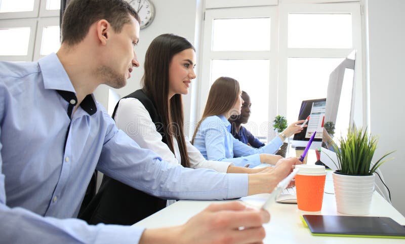 Team of Colleagues Brainstorming Together while Working on the Computer ...