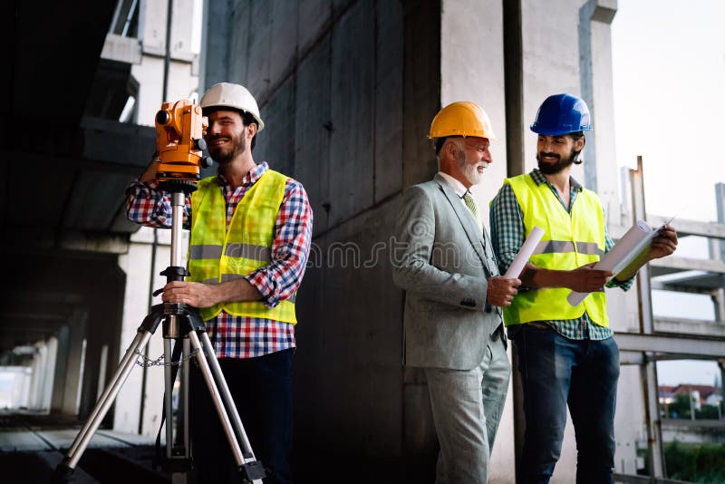 Team Of Construction Engineers Working On Building Site Stock Image ...