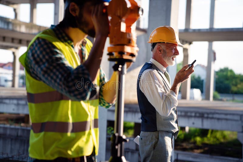 Team of Construction Engineers, Architects Working on Building Site ...