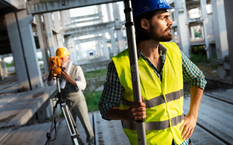 Team of Construction Engineers, Architects Working on Building Site ...