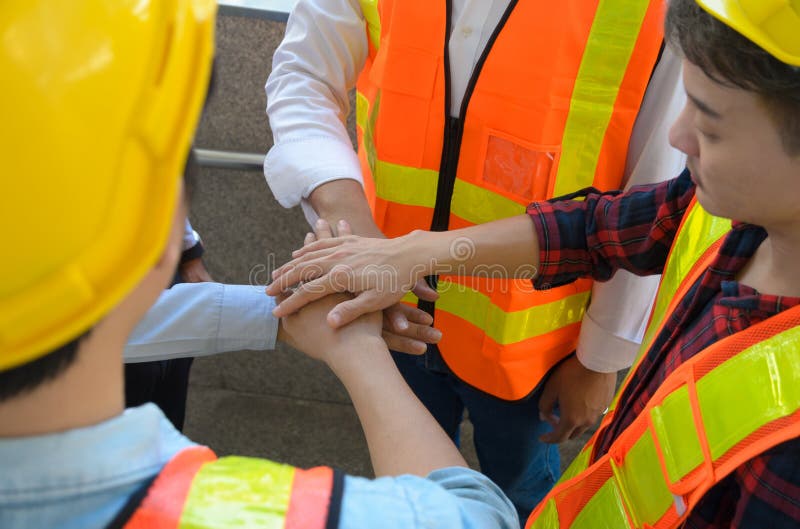 Team of Construction Engineers and Workers Joining Hands Together ...
