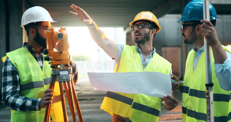 Team of Construction Engineers Working on Building Site Stock Photo ... Team of Construction Engineers Working on Building Site Stock Photo ...