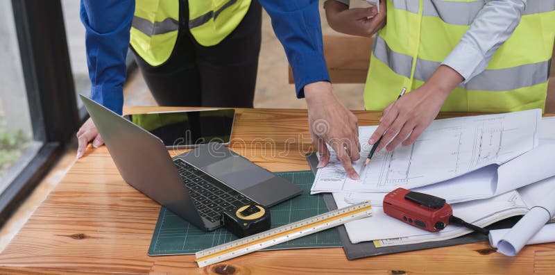 A Team of Construction Engineers Works in an Office on a Construction ...