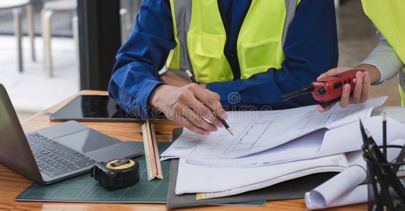 A Team of Construction Engineers Works in an Office on a Construction ...