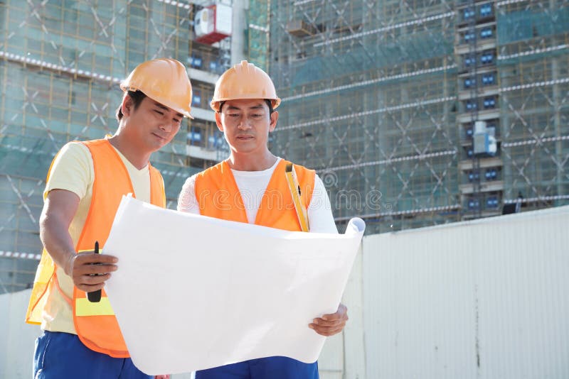 Construction Workers Discussing Building Plan Stock Image - Image of ...