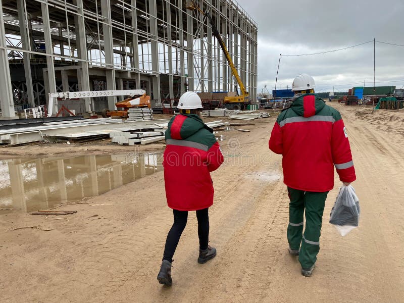 A Team of Construction Workers with Helmets at Work Place in a Factory ...