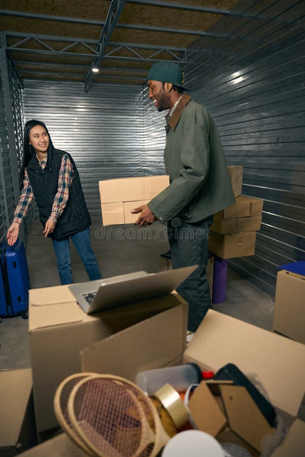 Team of Coworkers Containerizing Wares in Storage Unit Stock Image ...