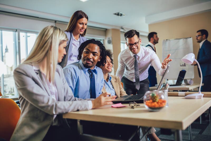 Creative People Looking at Colleague Showing Project Plan on His Laptop ...