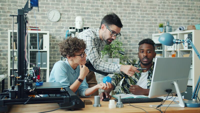 Team of Designers Making Robot Details with 3d Printer Talking Using ...