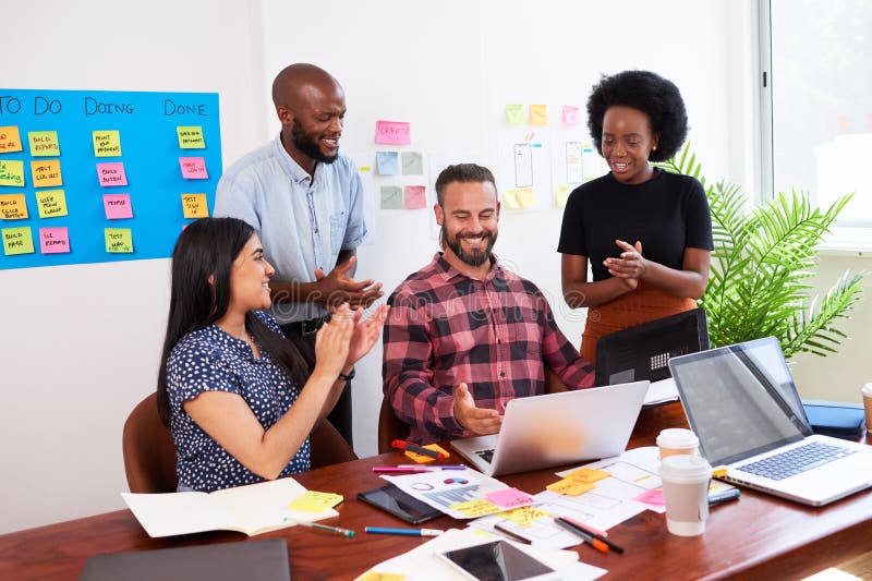 Team of Developers Clapping Hands during Brainstorm Meeting in ...