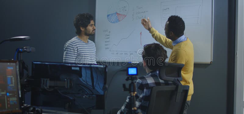 Team Discussing a Case or Feature Stock Photo - Image of standing, male ...