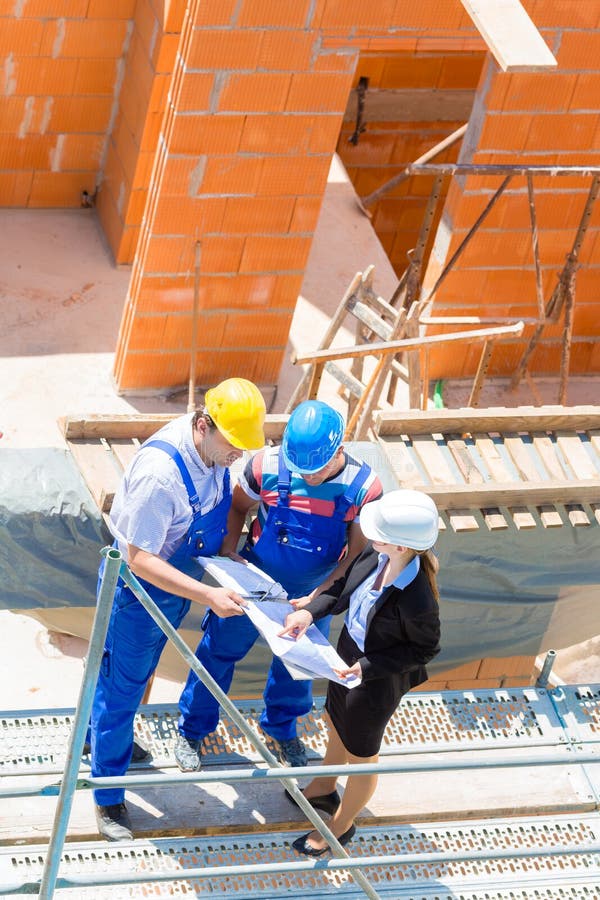Team Discussing Construction or Building Site Plans Stock Image - Image ...
