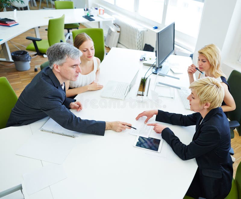 Team Discussing at Desk in Business Meeting Stock Photo - Image of ...