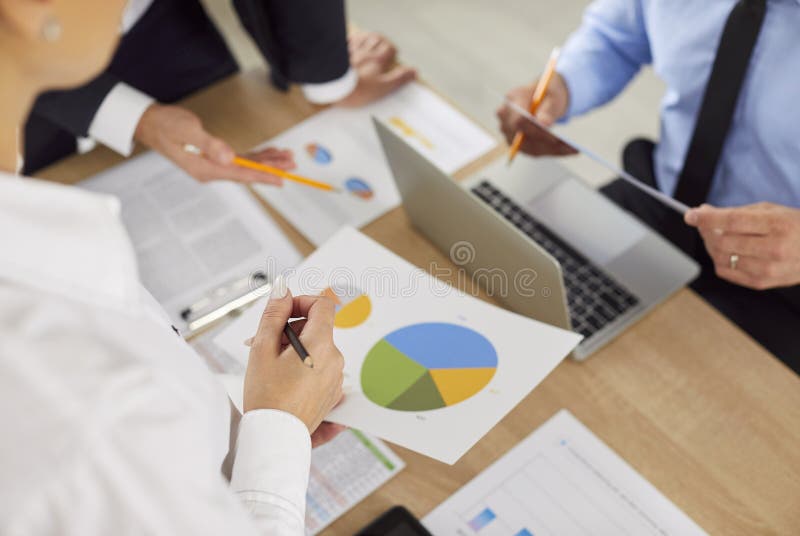 Team Discussing Document with Pie Charts Close Up, Business People ...